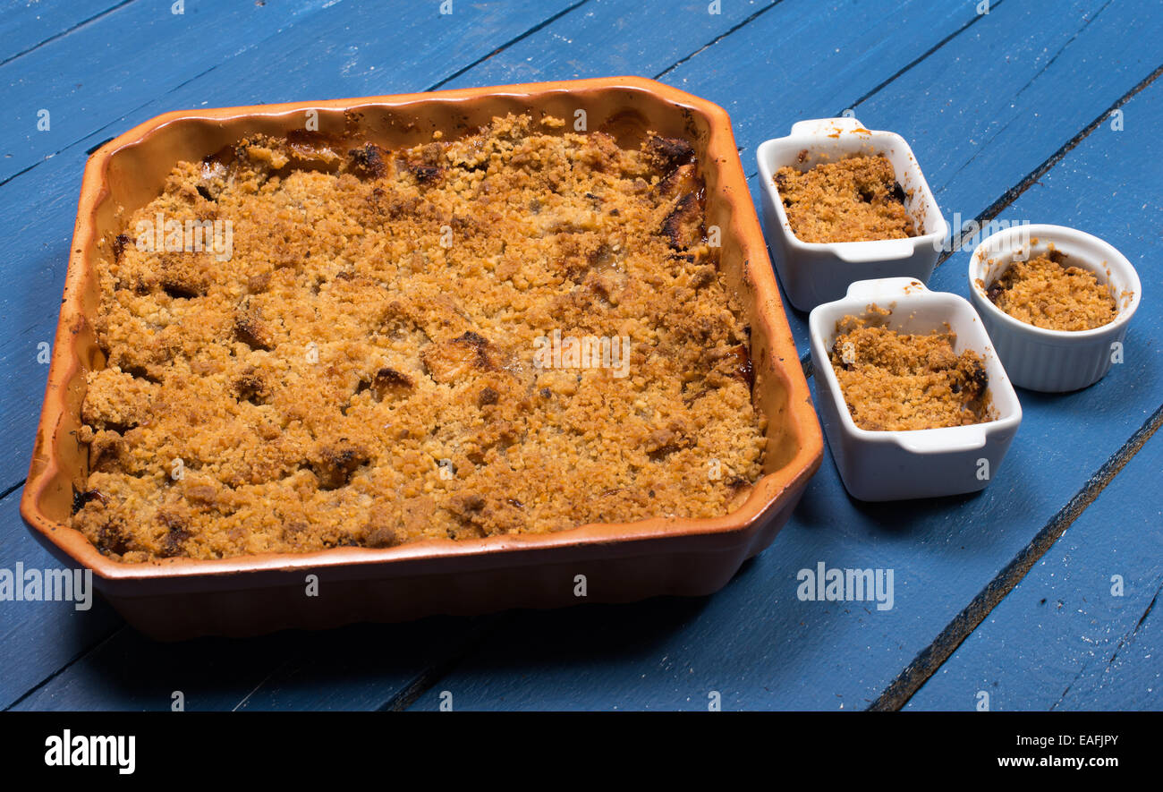 apple crumble on a blue wooden table Stock Photo - Alamy