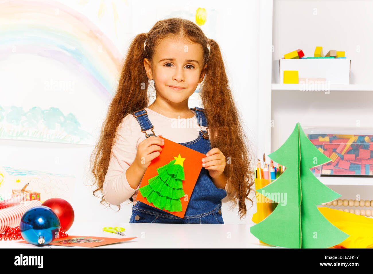 Beautiful girl holding handmade carton card Stock Photo - Alamy