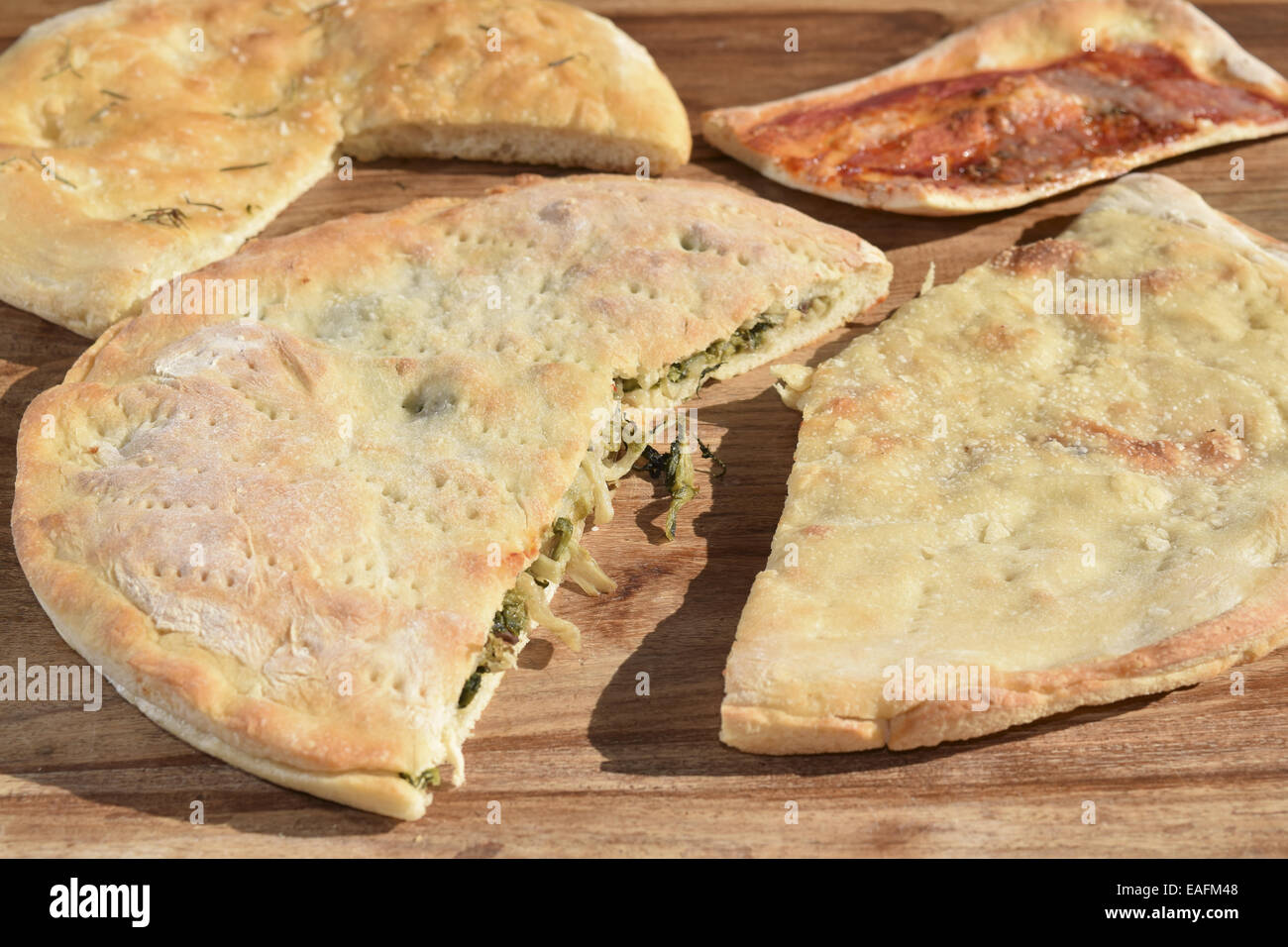 variety of stuffed pizzas with vegetable and ham Stock Photo - Alamy