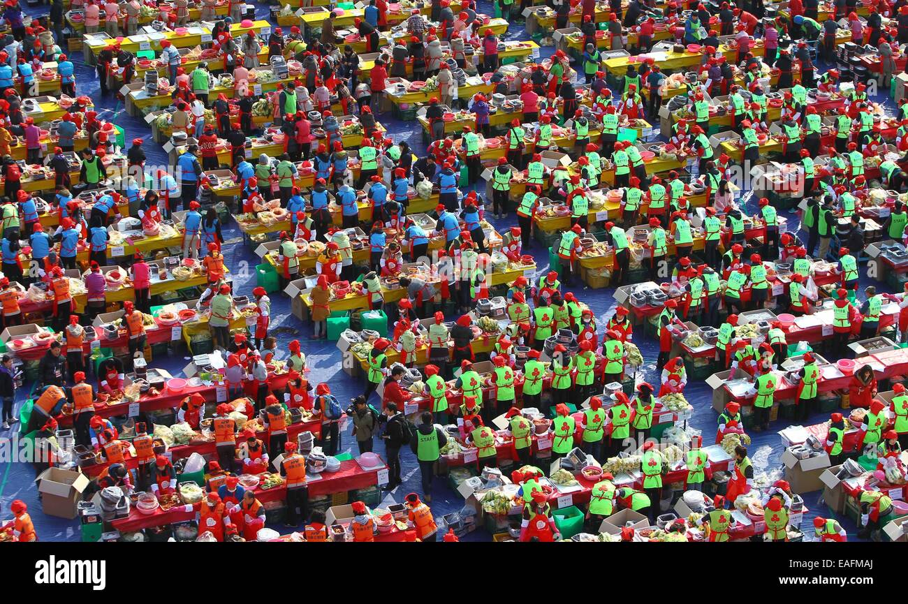 Seoul, South Korea. 14th Nov, 2014. Participants make kimchi, a ...