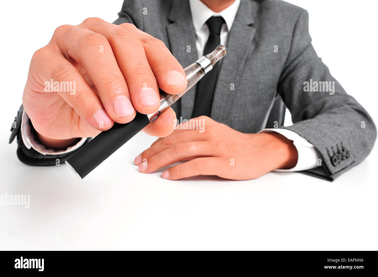man wearing a suit vaping with an electronic cigarette Stock Photo - Alamy