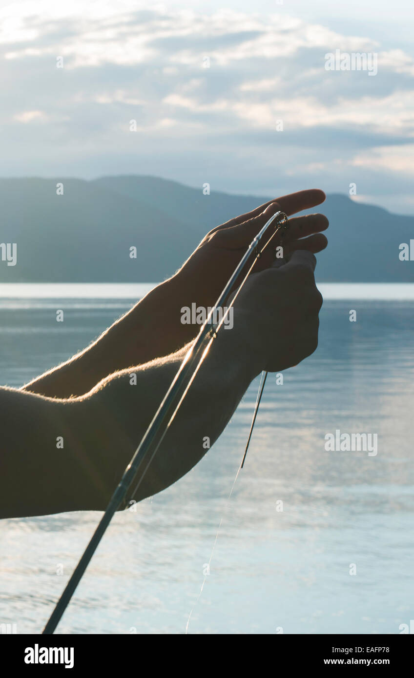 Preparing for fishing. Man put a hook Stock Photo - Alamy