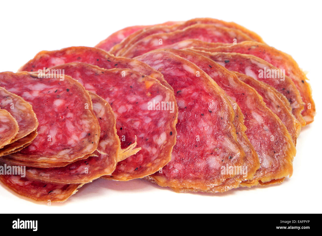 some slices of salchichon, spanish cured sausage, on a white background ...