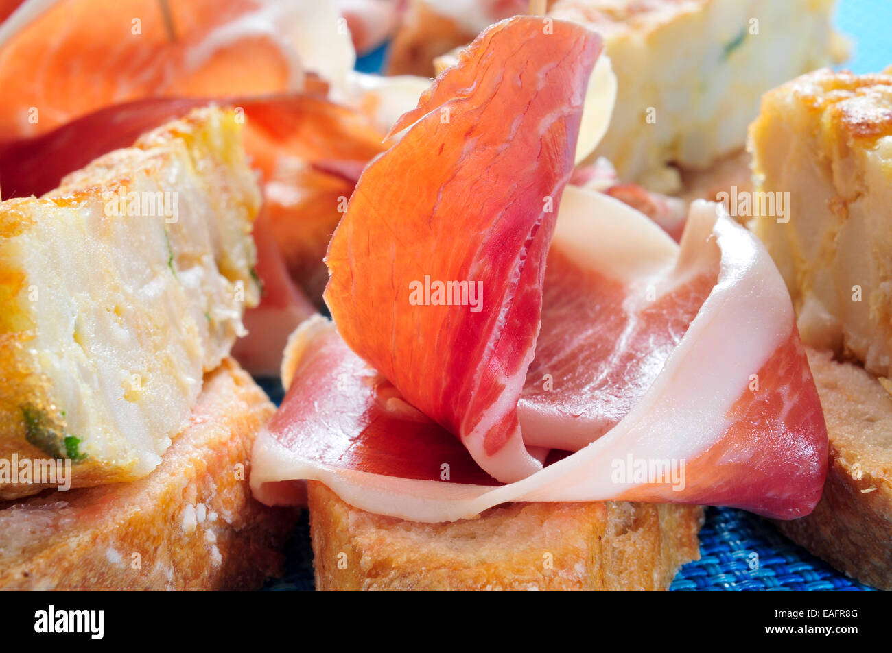 closeup of a plate with some typical spanish pincho de tortilla and ...