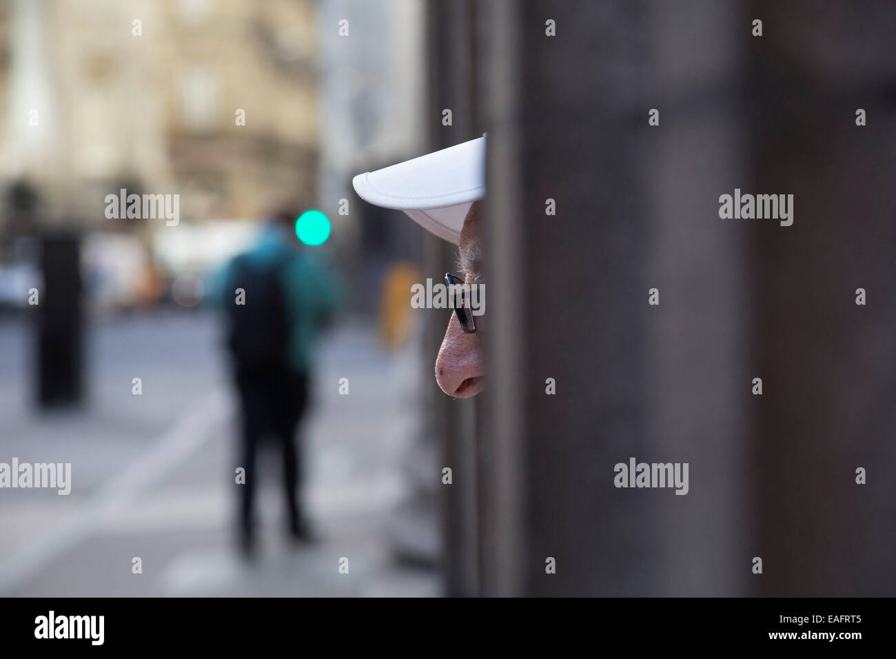 The nose of a man poking out from where he is sitting in the City of ...