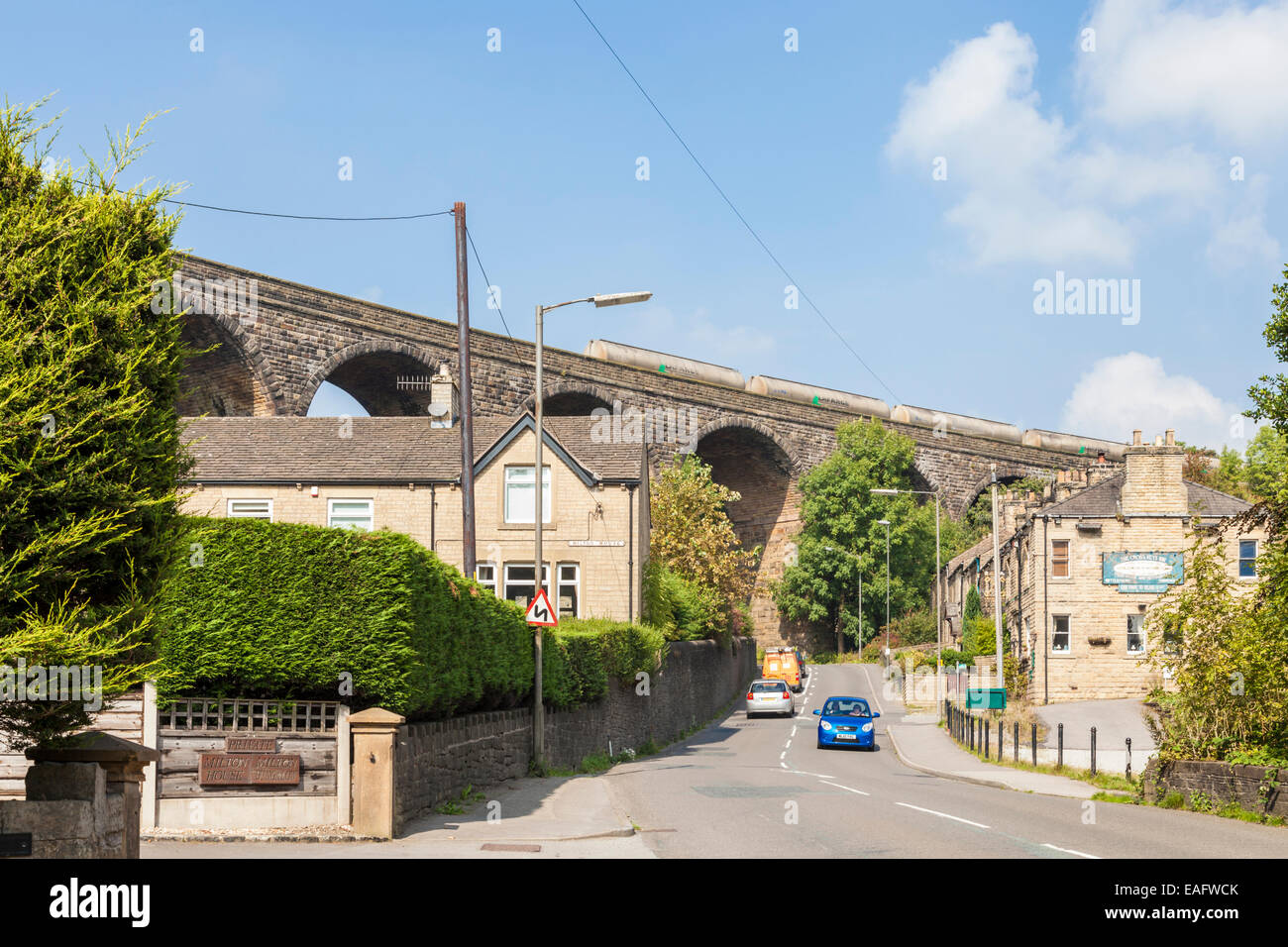 The hamlet of Chapel Milton with a railway viaduct high above the road ...
