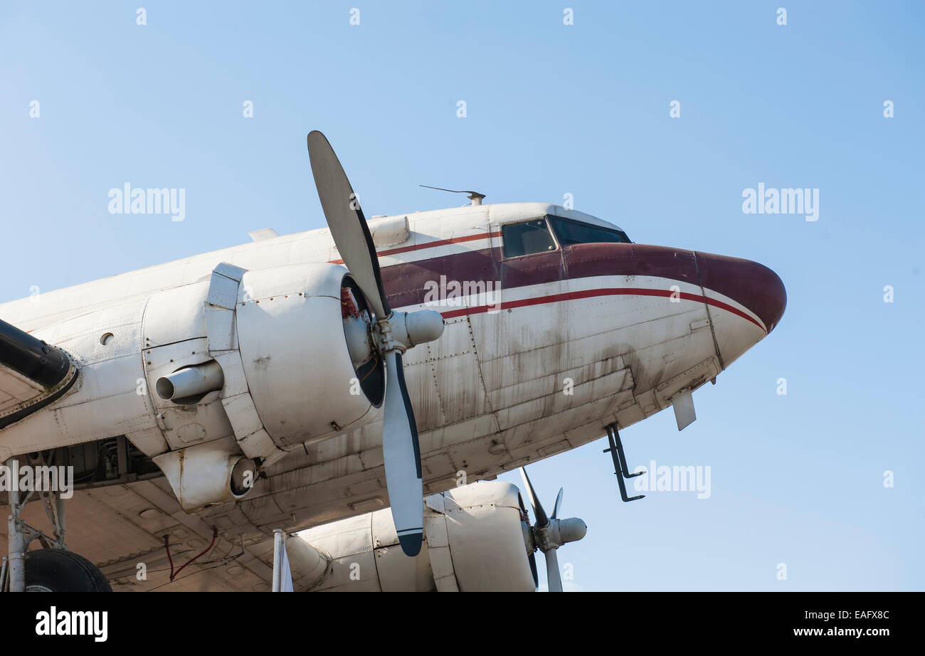 Front of old propeller passenger airplane against blue sky background ...