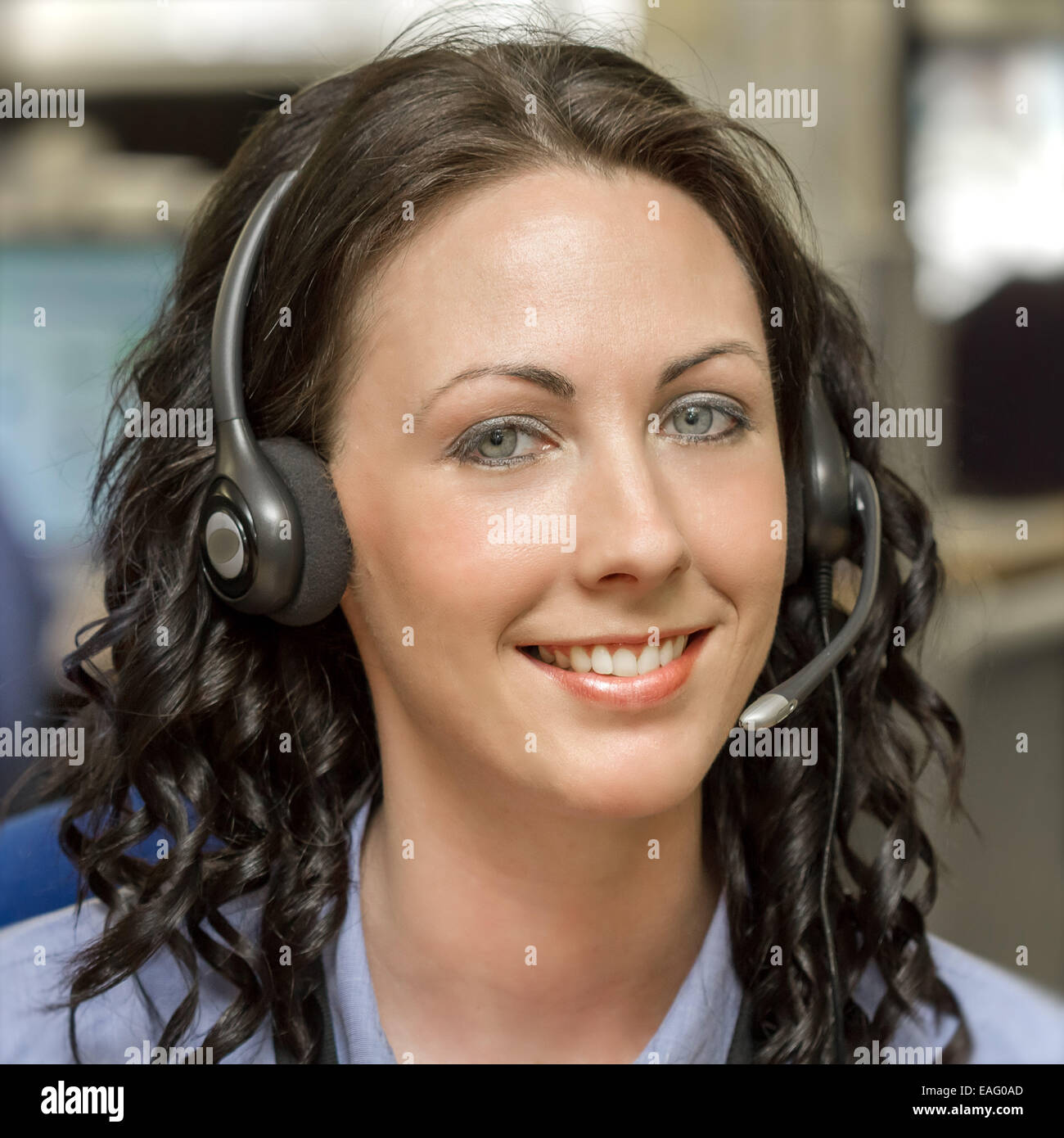 Call Centre staff - young dark haired woman wearing an audio headset ...