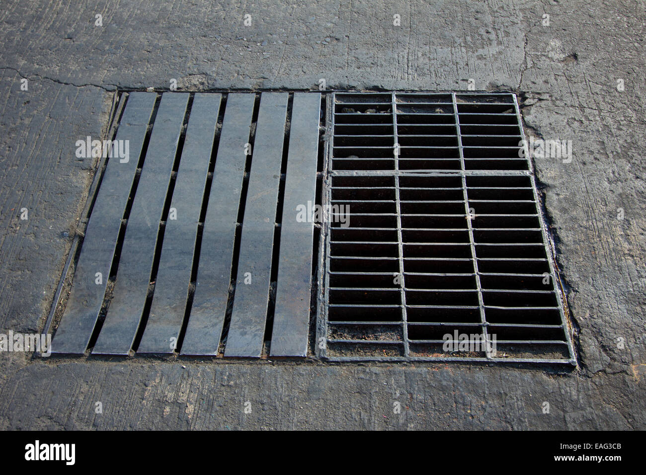 Drain grating on road in Thailand Stock Photo - Alamy