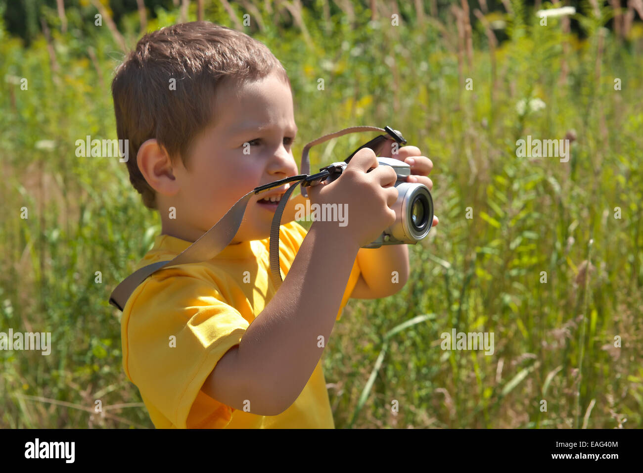 Little boy ready to take picture with his camera Stock Photo - Alamy
