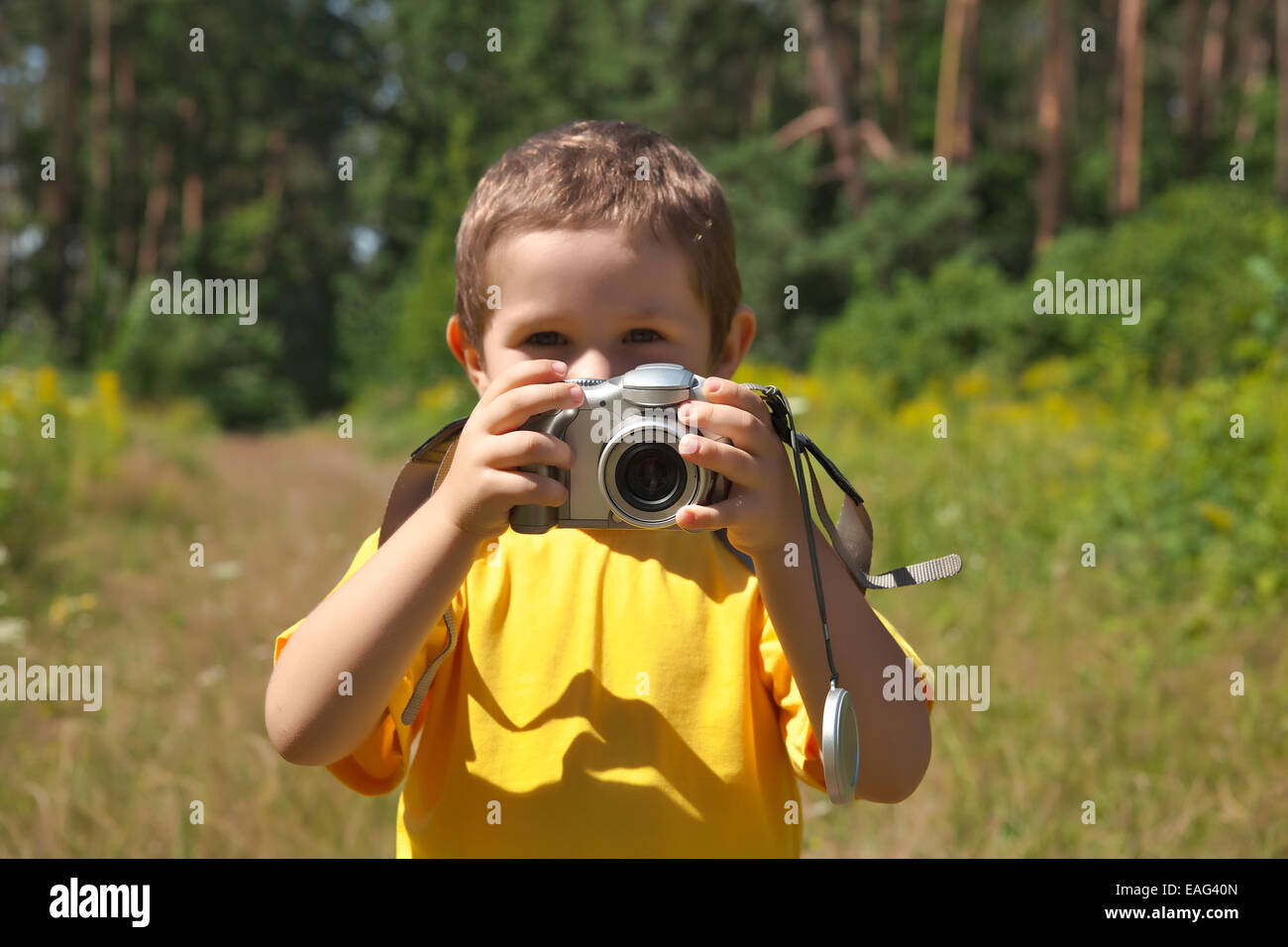 Little boy ready to take picture and looking at you Stock Photo - Alamy