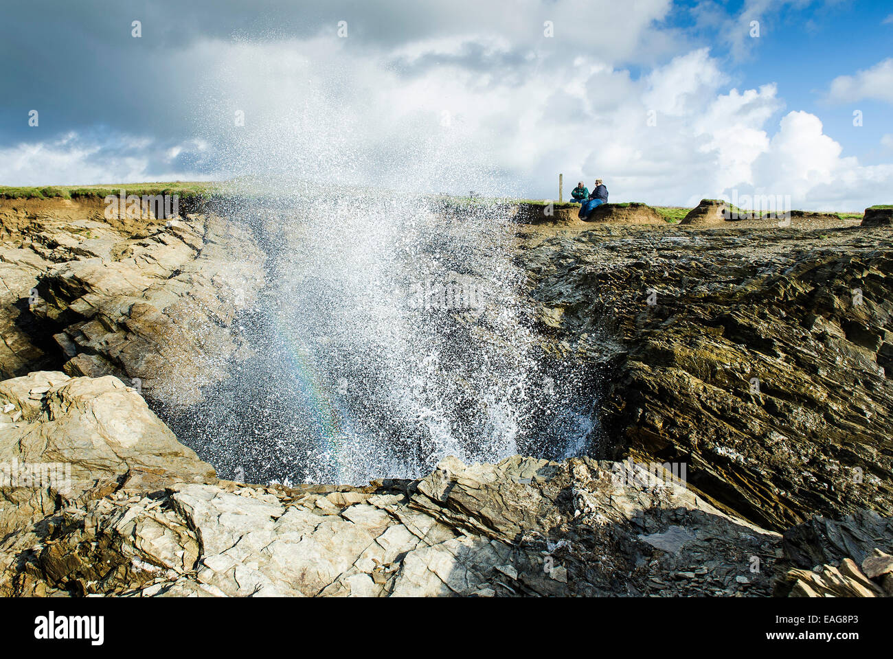 Spray from waves crashing onto rocks on Porth Island in Newquay Stock ...
