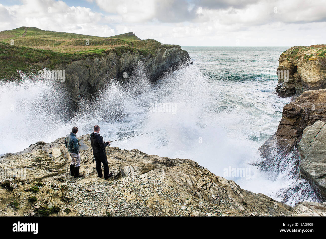 Two anglers fishing from rocks on Porth Island in Newquay, Cornwall ...