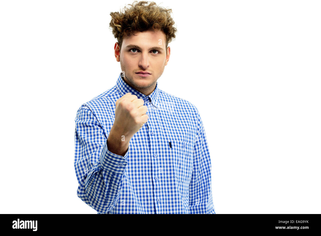 Serious angry man showing fist over white background Stock Photo - Alamy