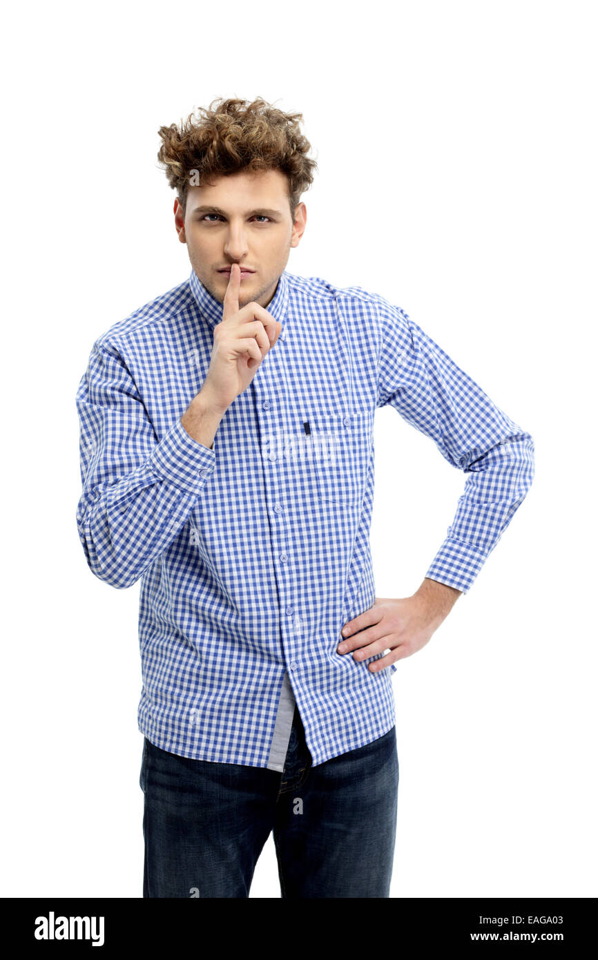 Young man making silence gesture Stock Photo - Alamy