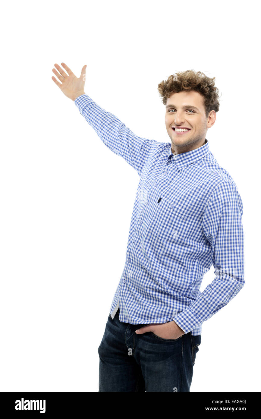 Portrait of a handsome young man gesturing welcome Stock Photo - Alamy