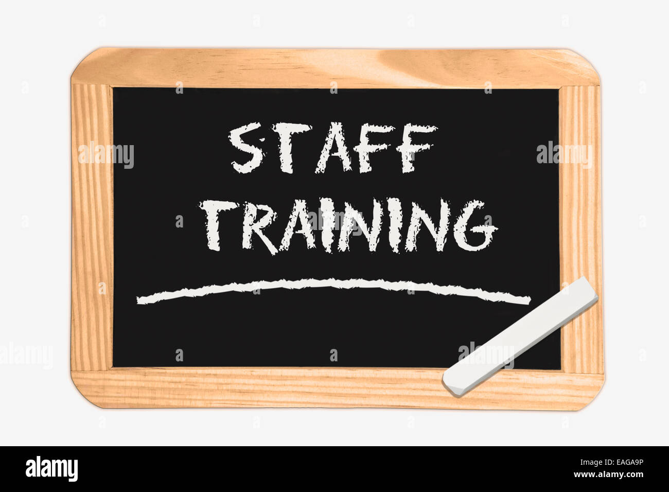 Blackboard with the inscription Staff Training, a piece of white chalk ...