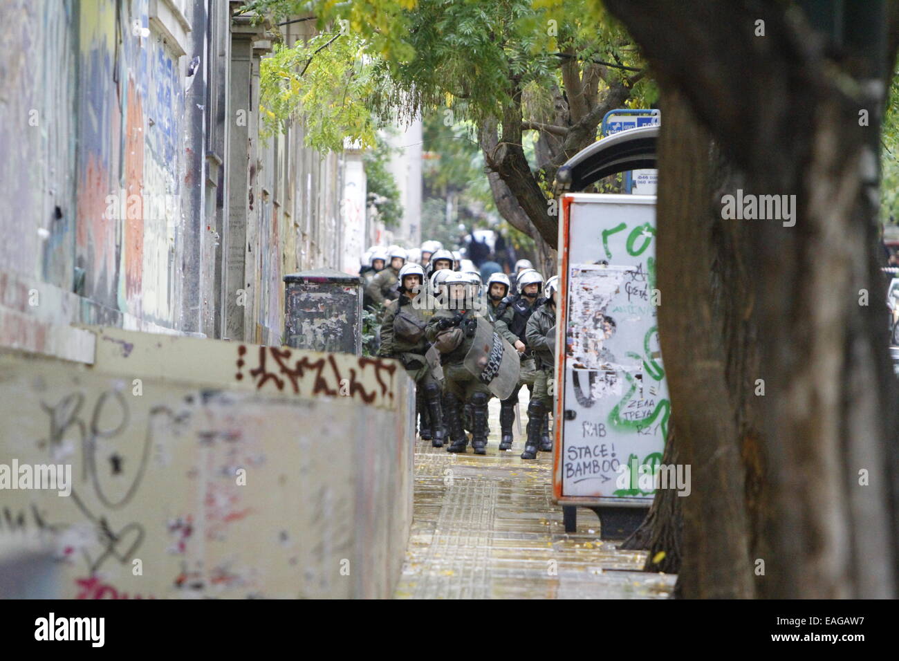 Riot police officers stand outside the side gate of the Athens ...