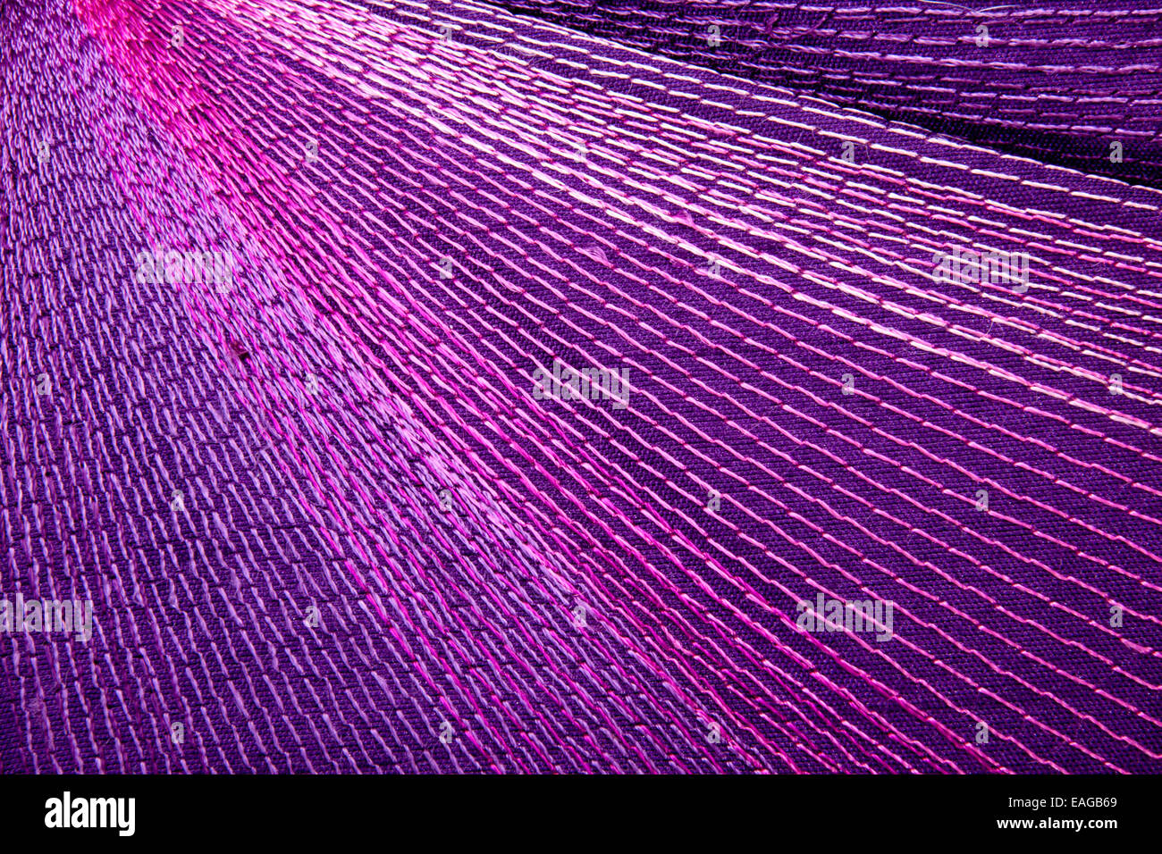 intricate colorful stitching forming pattern on mauve fabric Stock ...