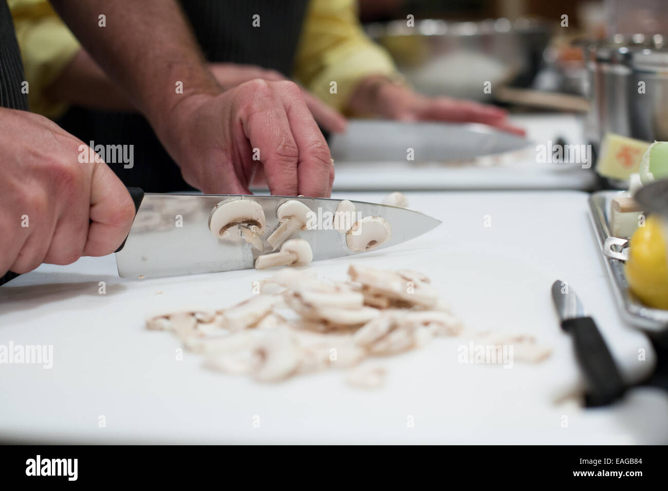 Hands chopping raw mushrooms on a cutting board Stock Photo - Alamy
