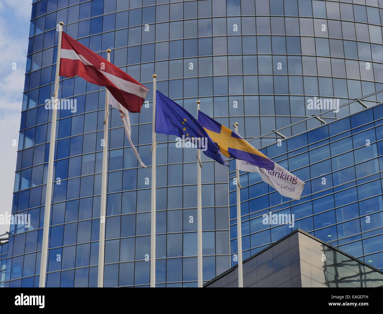 many countries flags on blue glass building background Stock Photo - Alamy