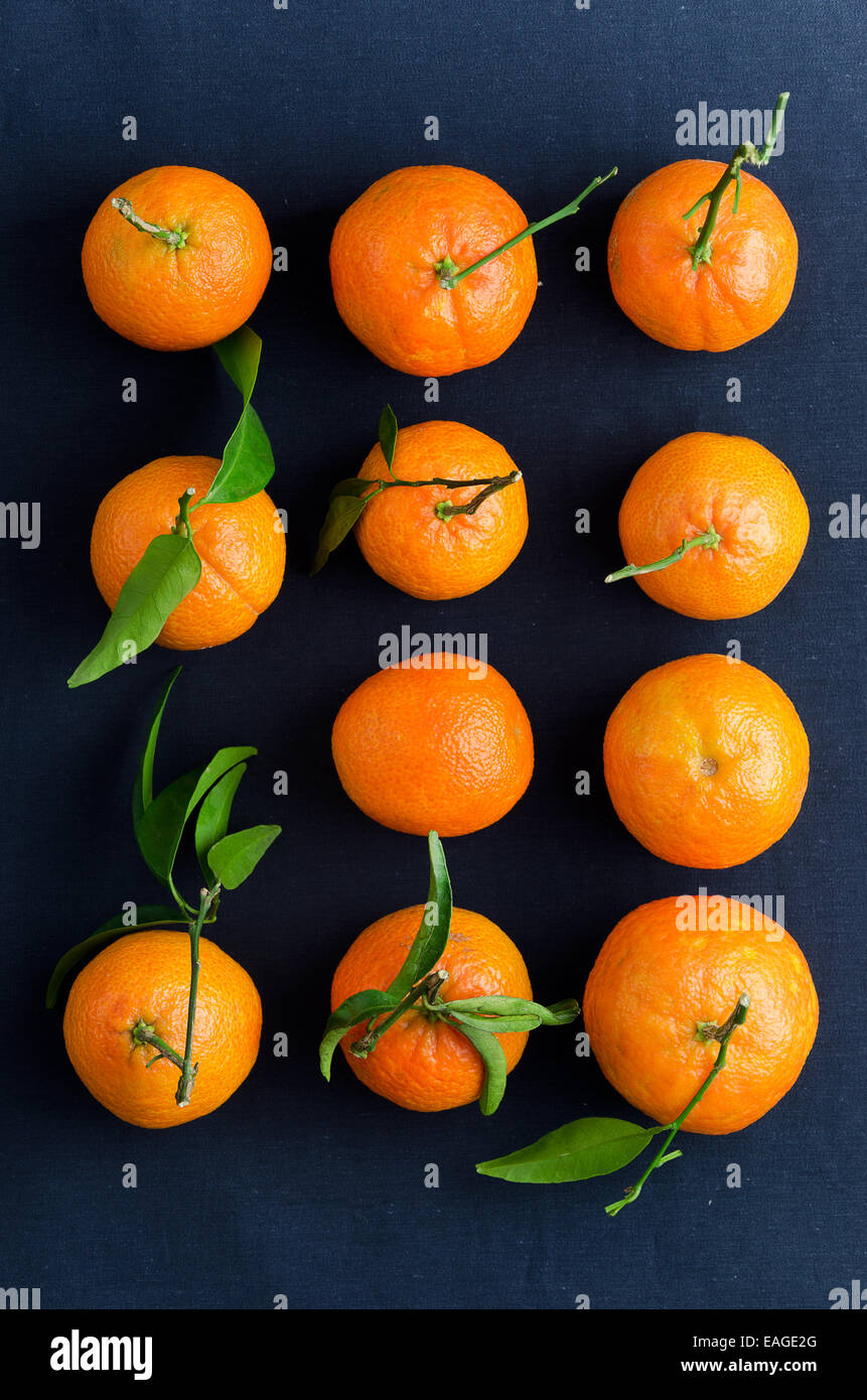 Multiple ripe tangerines over dark blue cloth, overhead view Stock ...