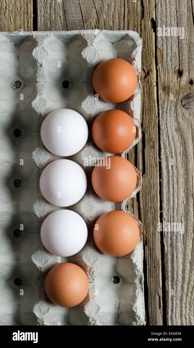 Eggs in formwork over wooden table Stock Photo - Alamy
