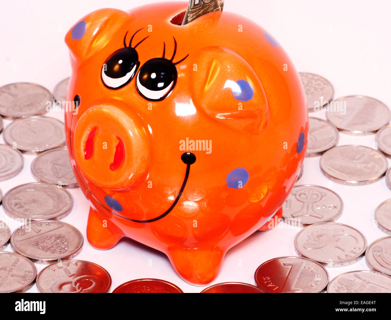 Bunch of Latvian lat coins and piggy bank on white background Stock ...