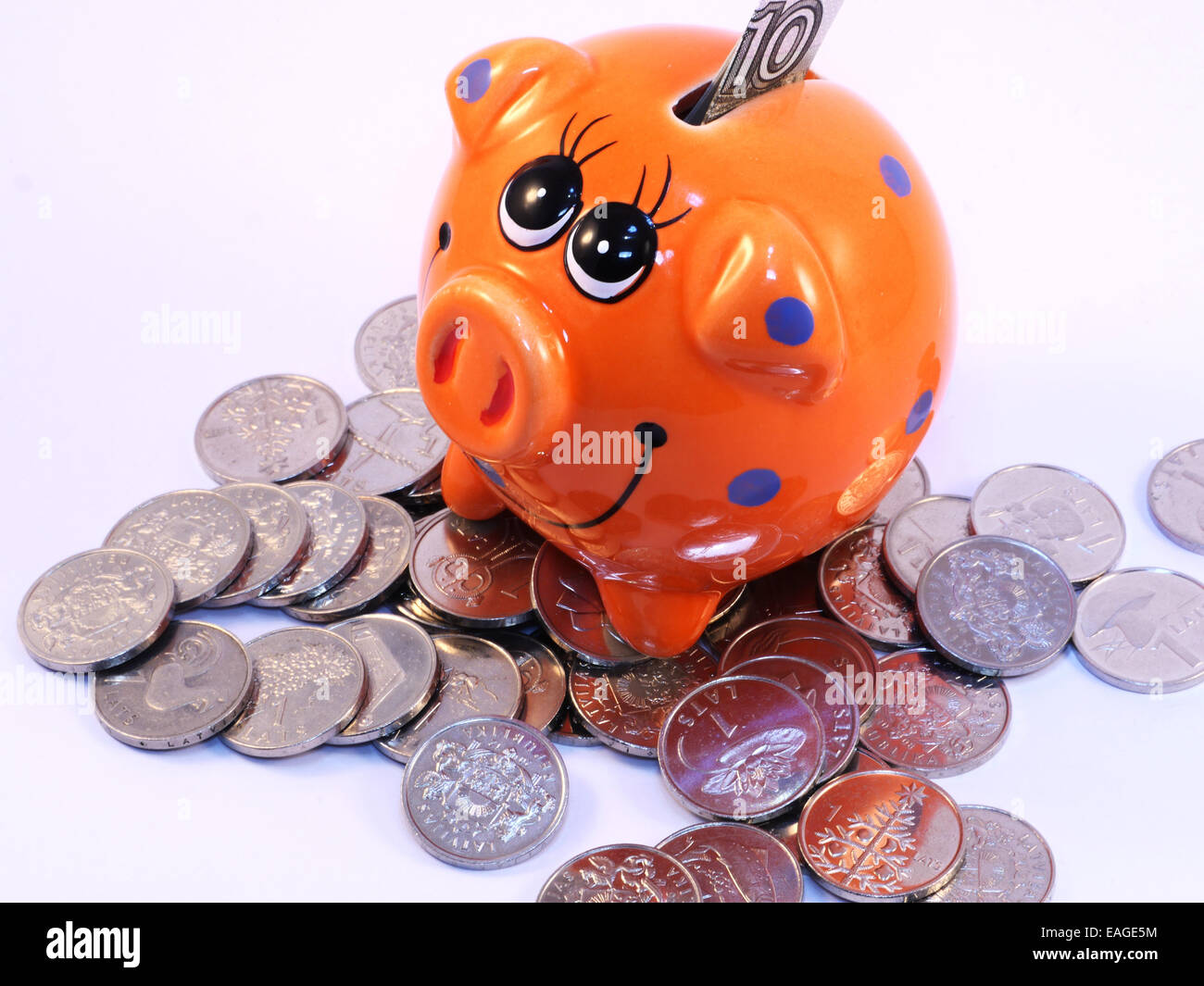 Bunch of Latvian lat coins and piggy bank on white background Stock ...