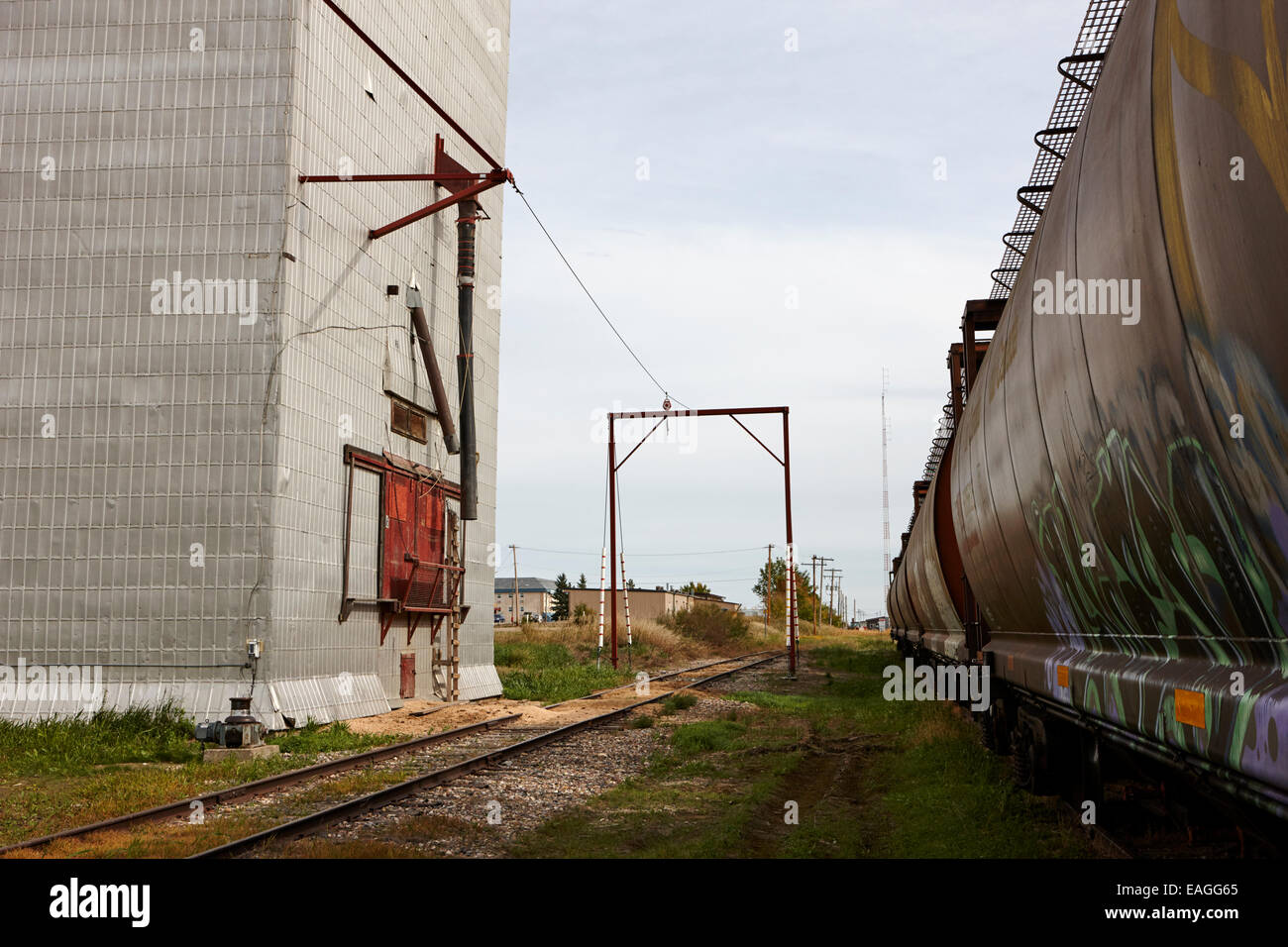 grain elevator and old train track with grain railcars leader ...