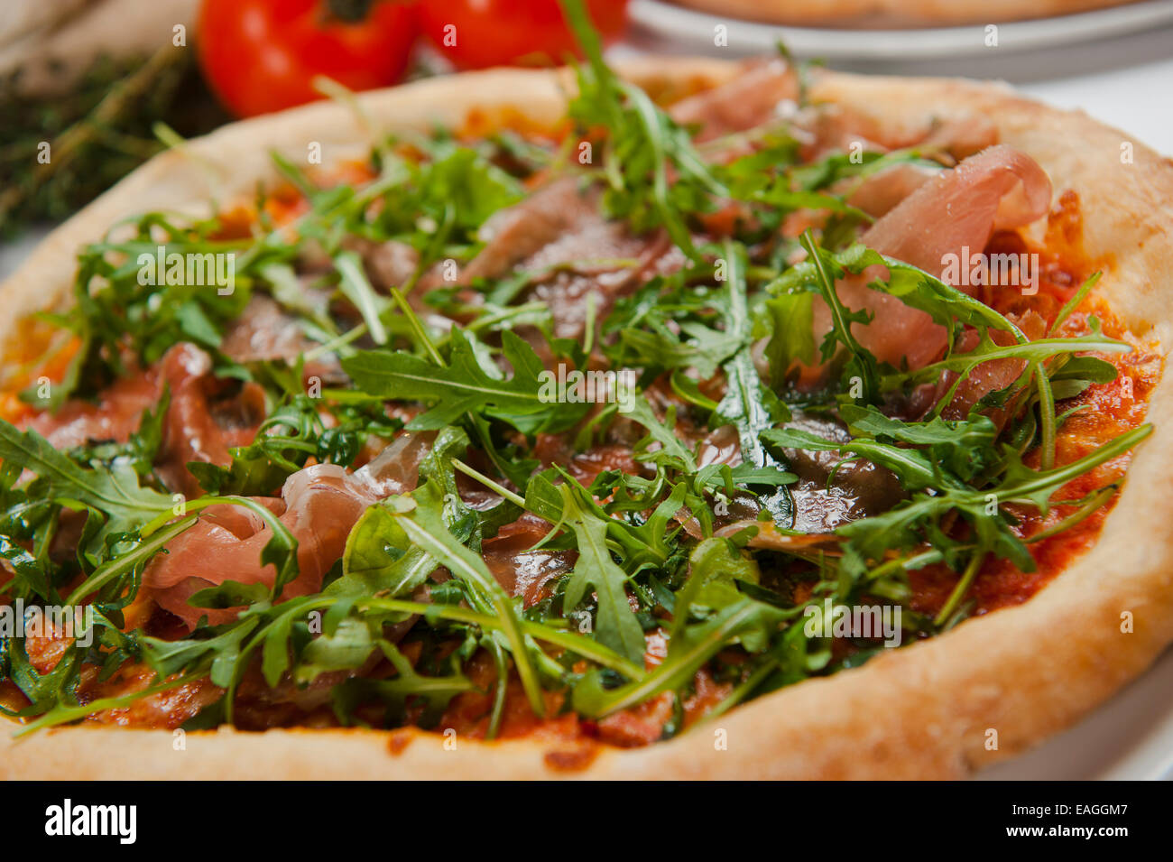 Italian Pizza with Salami Rocket and Basil Stock Photo - Alamy