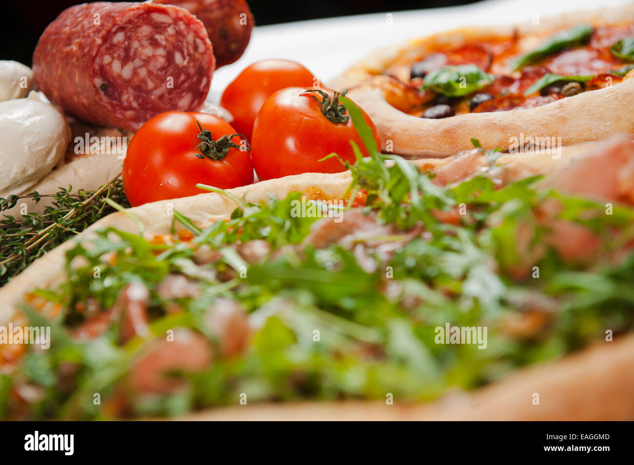 Italian Pizza with Salami Rocket and Basil Stock Photo - Alamy