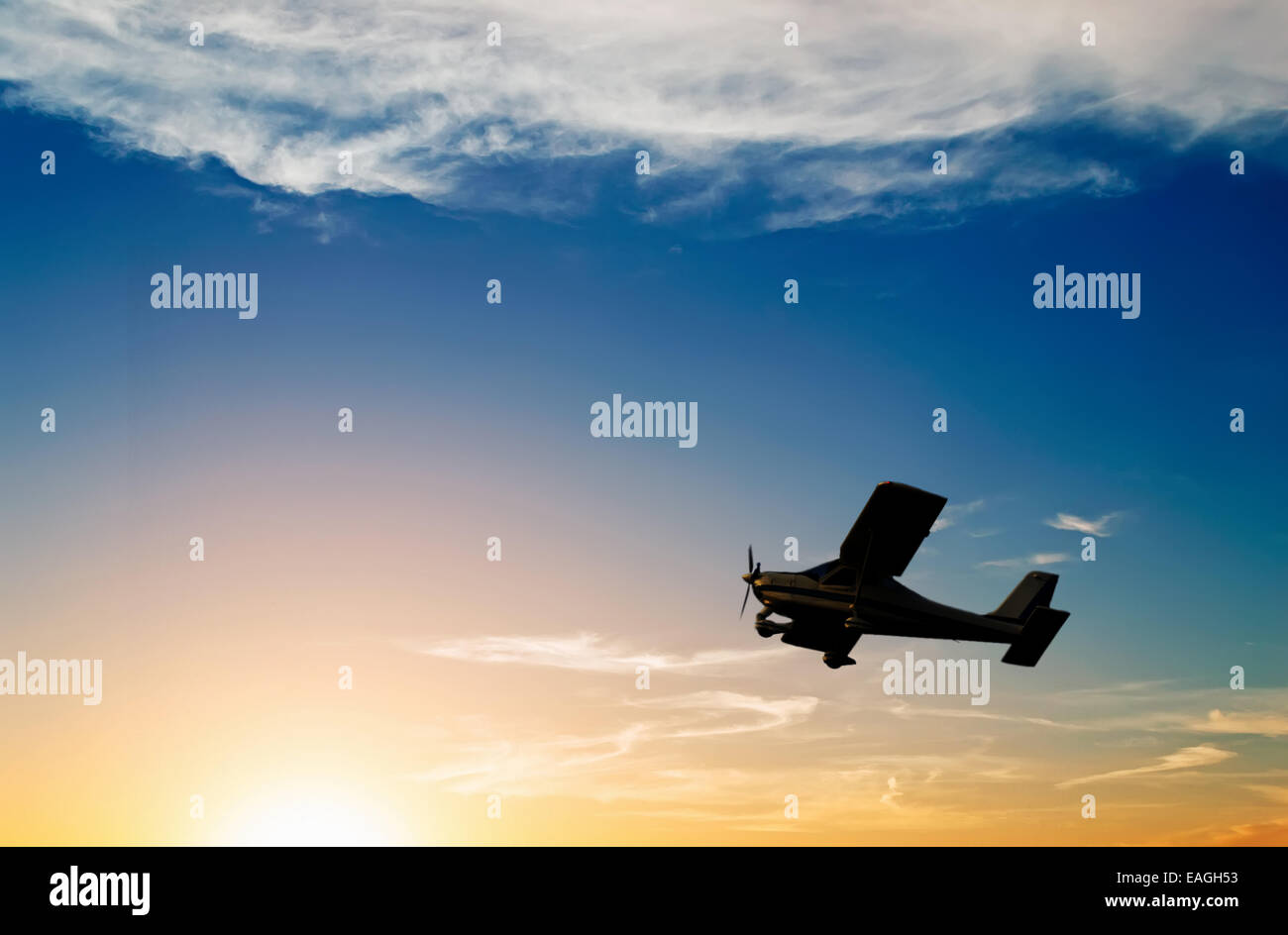 single engine airplane flying at sunset Stock Photo - Alamy