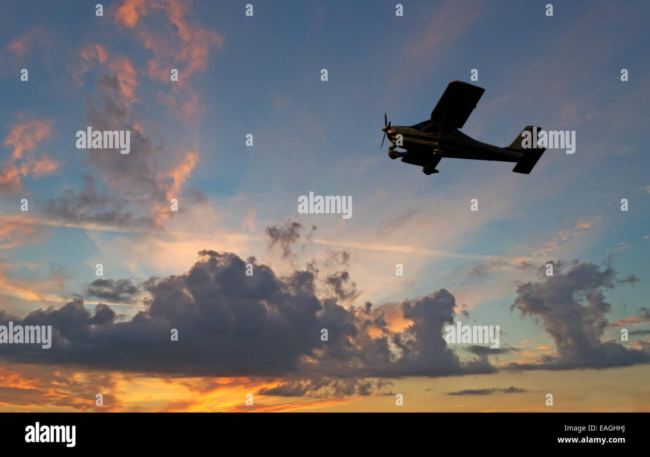 single engine airplane flying at sunset Stock Photo - Alamy