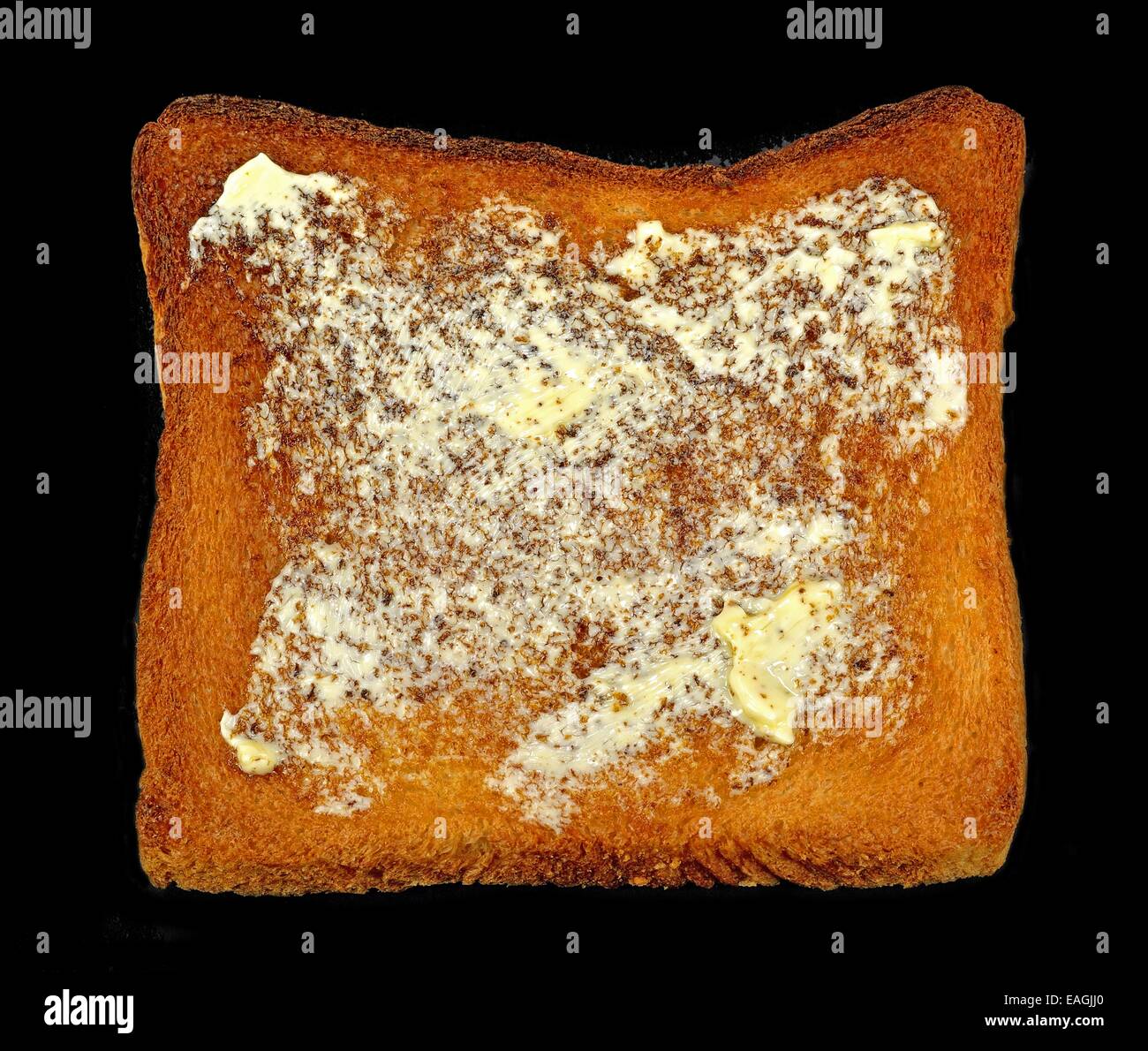 Slice of buttered white toast on a black background Stock Photo - Alamy