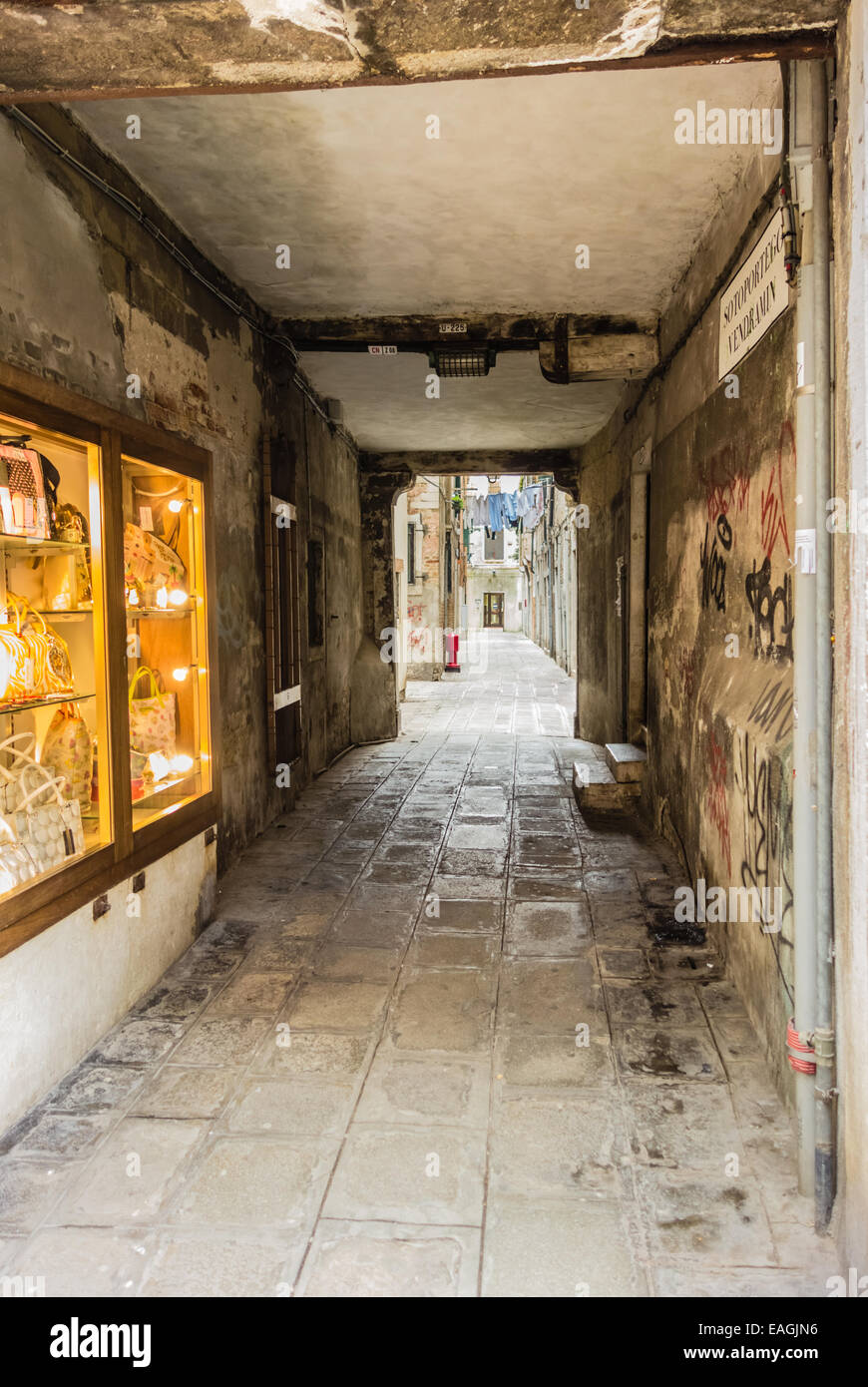 a narrow and dirty alley with graffiti in Venice, Italy Stock Photo - Alamy