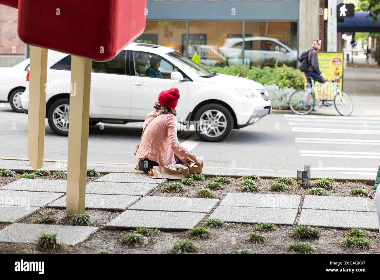 Young woman sitting on curb hi-res stock photography and images - Alamy