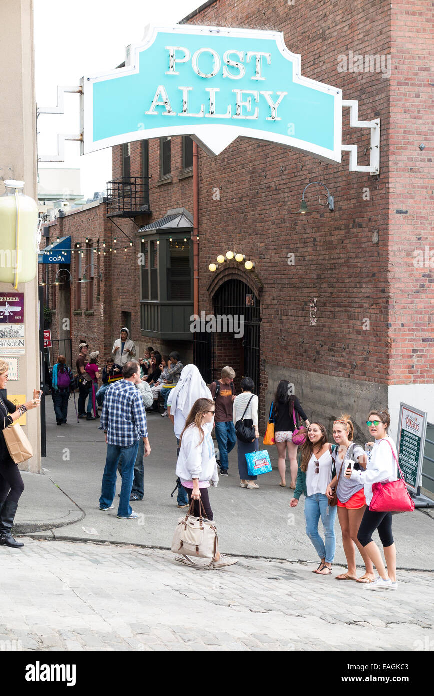 People walking along the Post Alley in Seattle - large sign Stock Photo ...