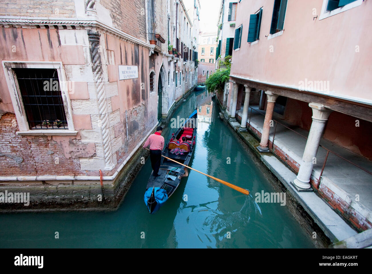 Gondoliero Rowing A Gondola In A Canal, Venice, Italy Stock Photo - Alamy
