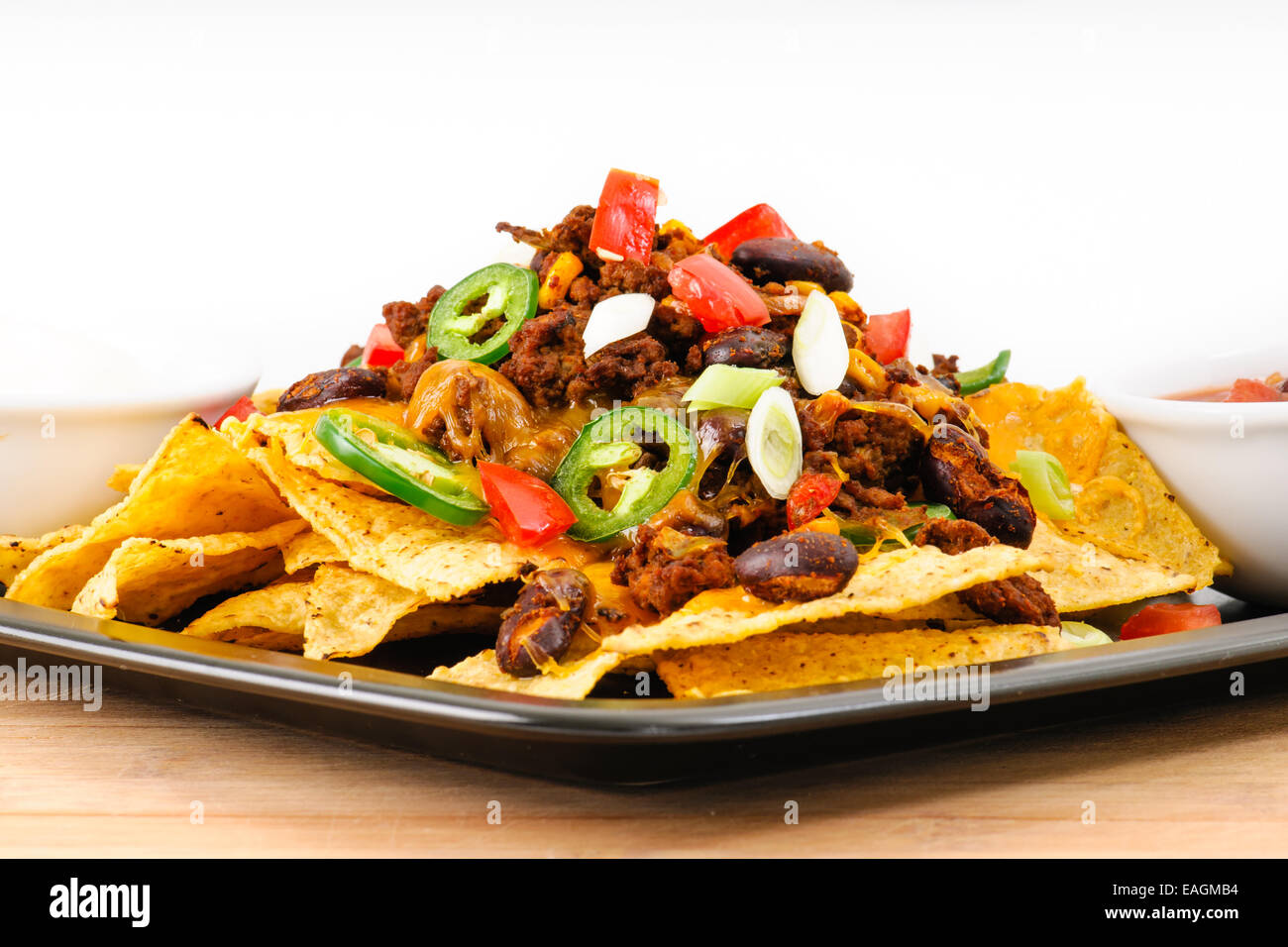 Chili and Cheddar Cheese Nacho platter with fresh Tomatoes, Onions ...