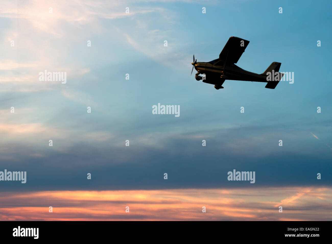 single engine airplane flying at sunset Stock Photo - Alamy