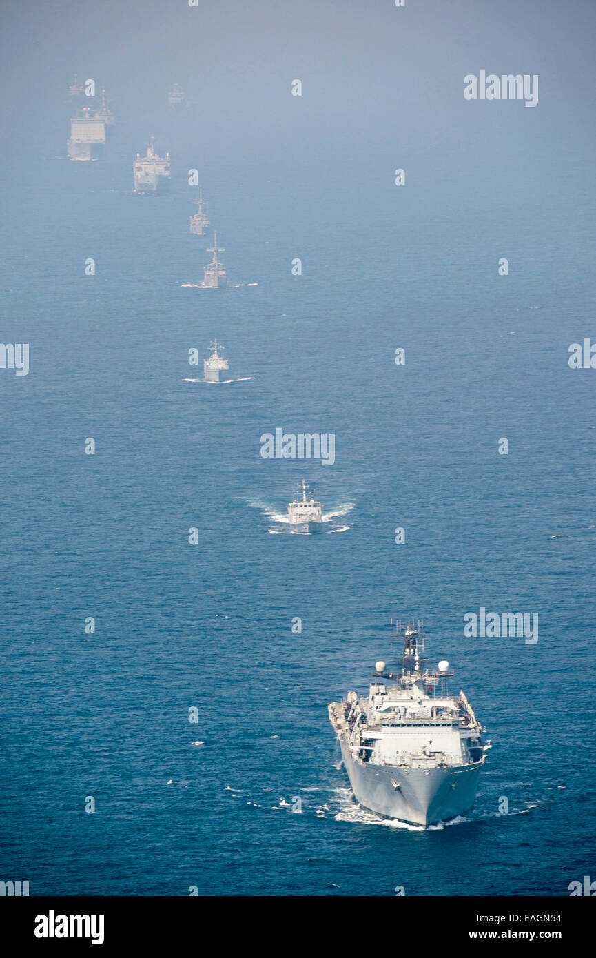 Navy ships led by the Royal Navy HMS Bulwark steam in formation during ...