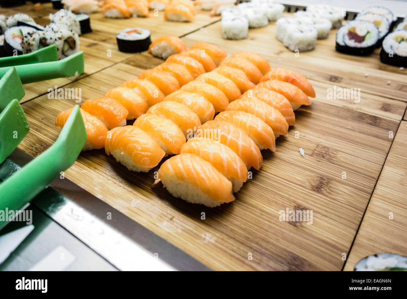 a lot of maki sushi on a wooden board Stock Photo - Alamy