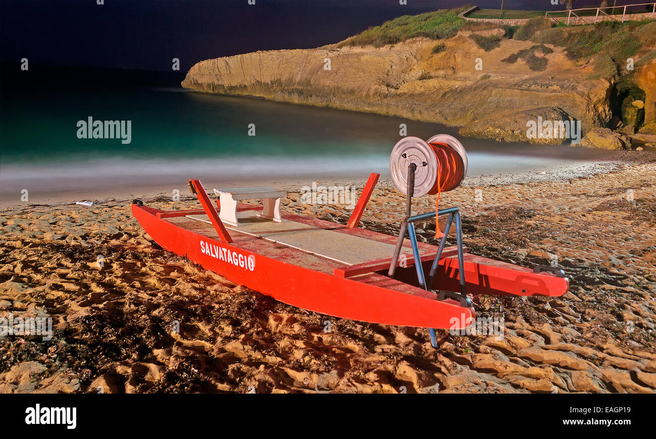 lifeboat by the shore at night Stock Photo - Alamy