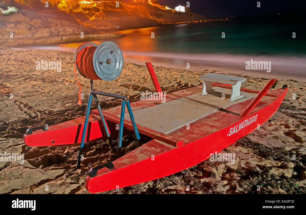 lifeboat by the shore at night Stock Photo - Alamy
