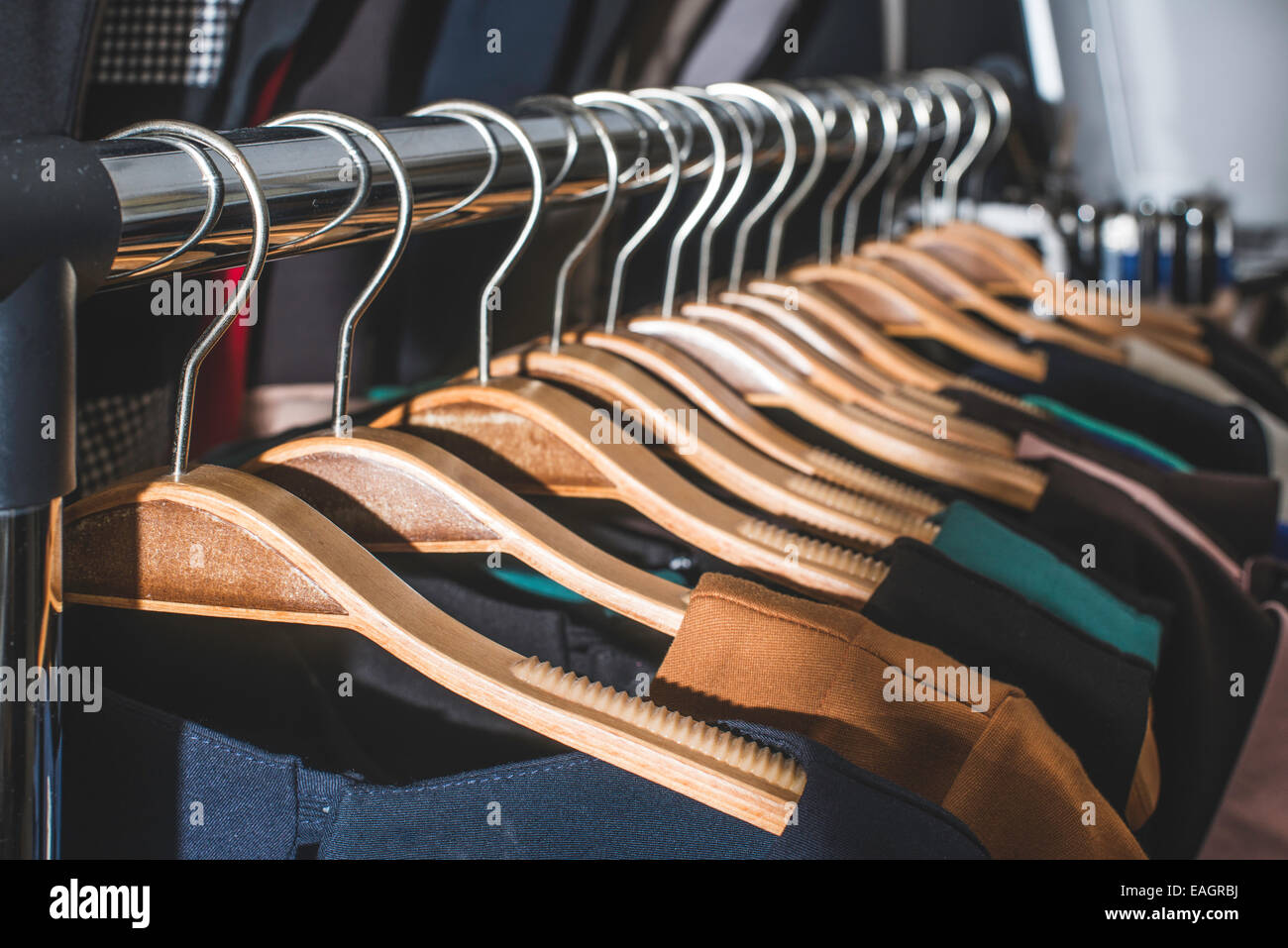 Clothes on hangers in shop. Close up Stock Photo - Alamy