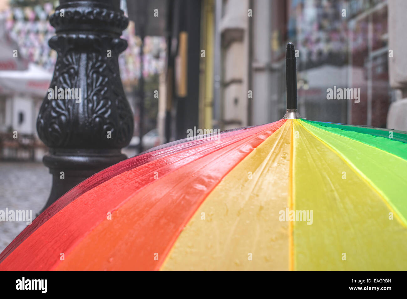 Multicolored umbrella in rainy day Stock Photo - Alamy