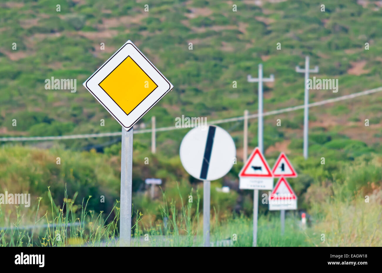 several road signs on the edge of the road Stock Photo - Alamy