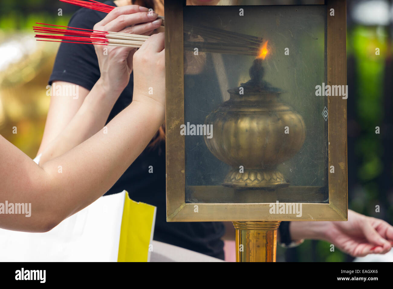 people lighting Incense sticks with lamp in Thailand Stock Photo - Alamy