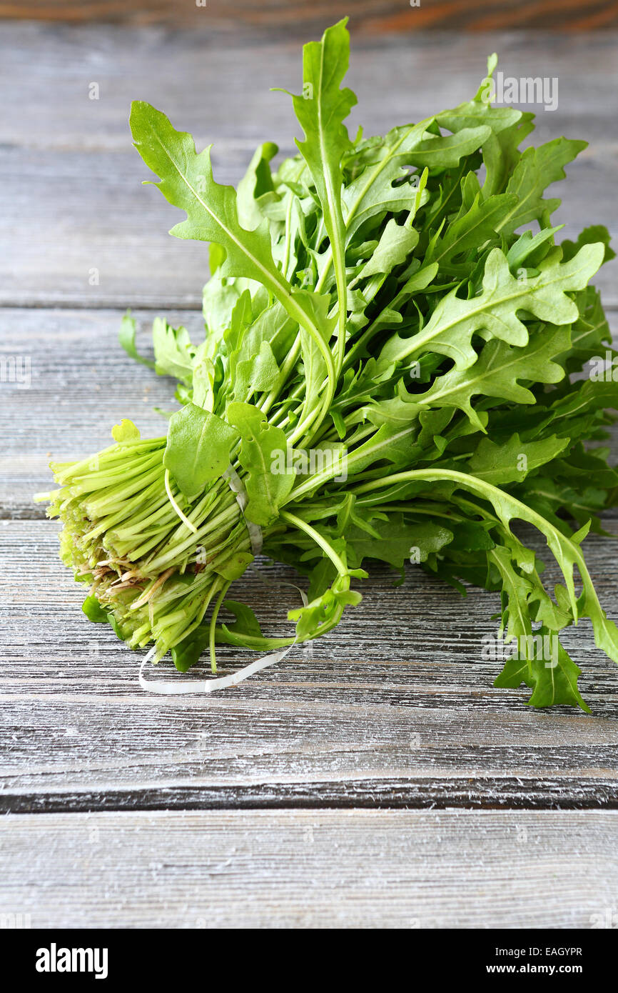 Arugula on wooden boards, healthy food Stock Photo - Alamy